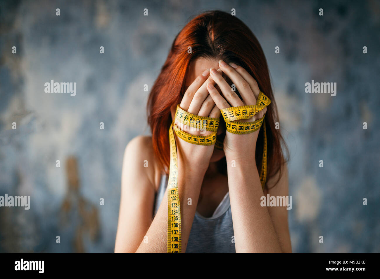 Woman with tape measure face hi-res stock photography and images - Alamy