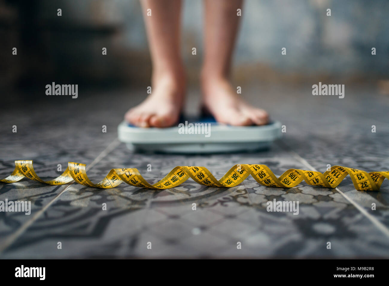 Female feet on scales hi-res stock photography and images - Alamy