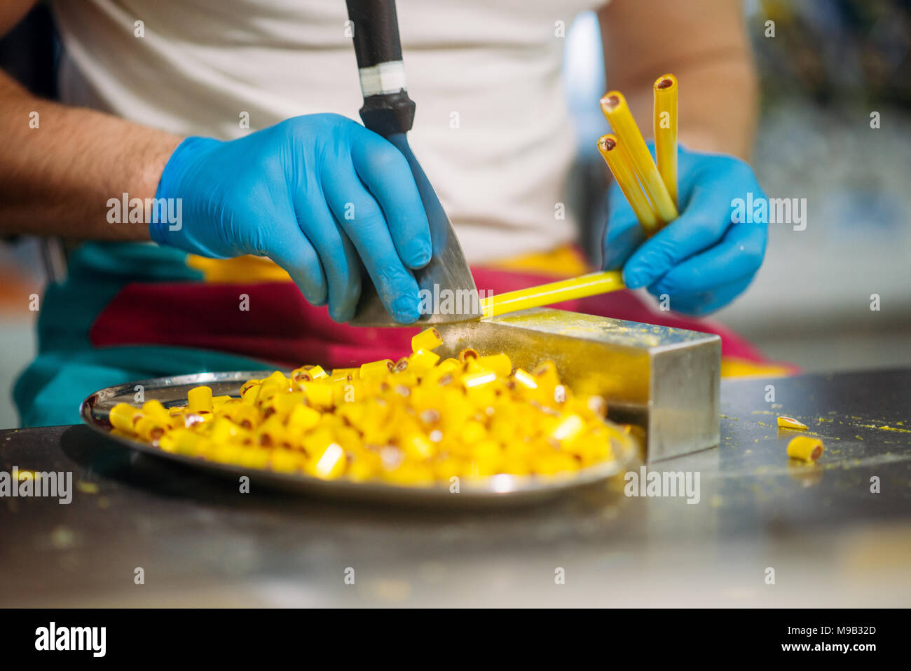 Master hands in gloves, caramel making process Stock Photo - Alamy