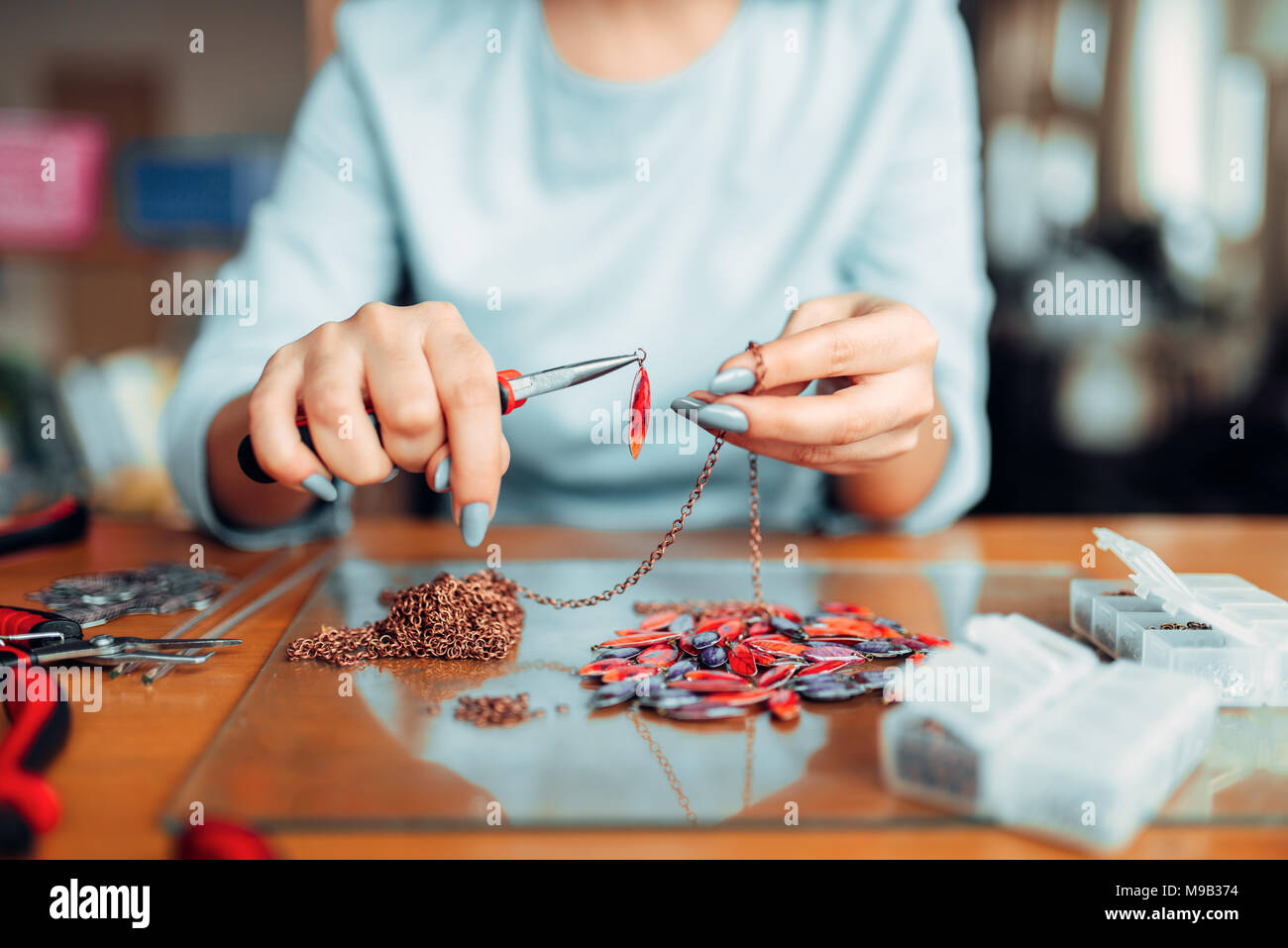 Female person holds pliers, bijouterie making Stock Photo - Alamy