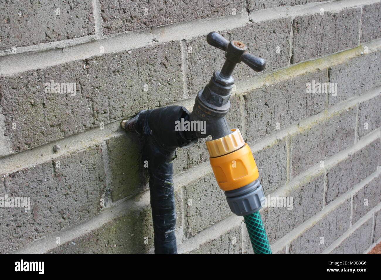 Hosepipe garden tap wall hi-res stock photography and images - Alamy