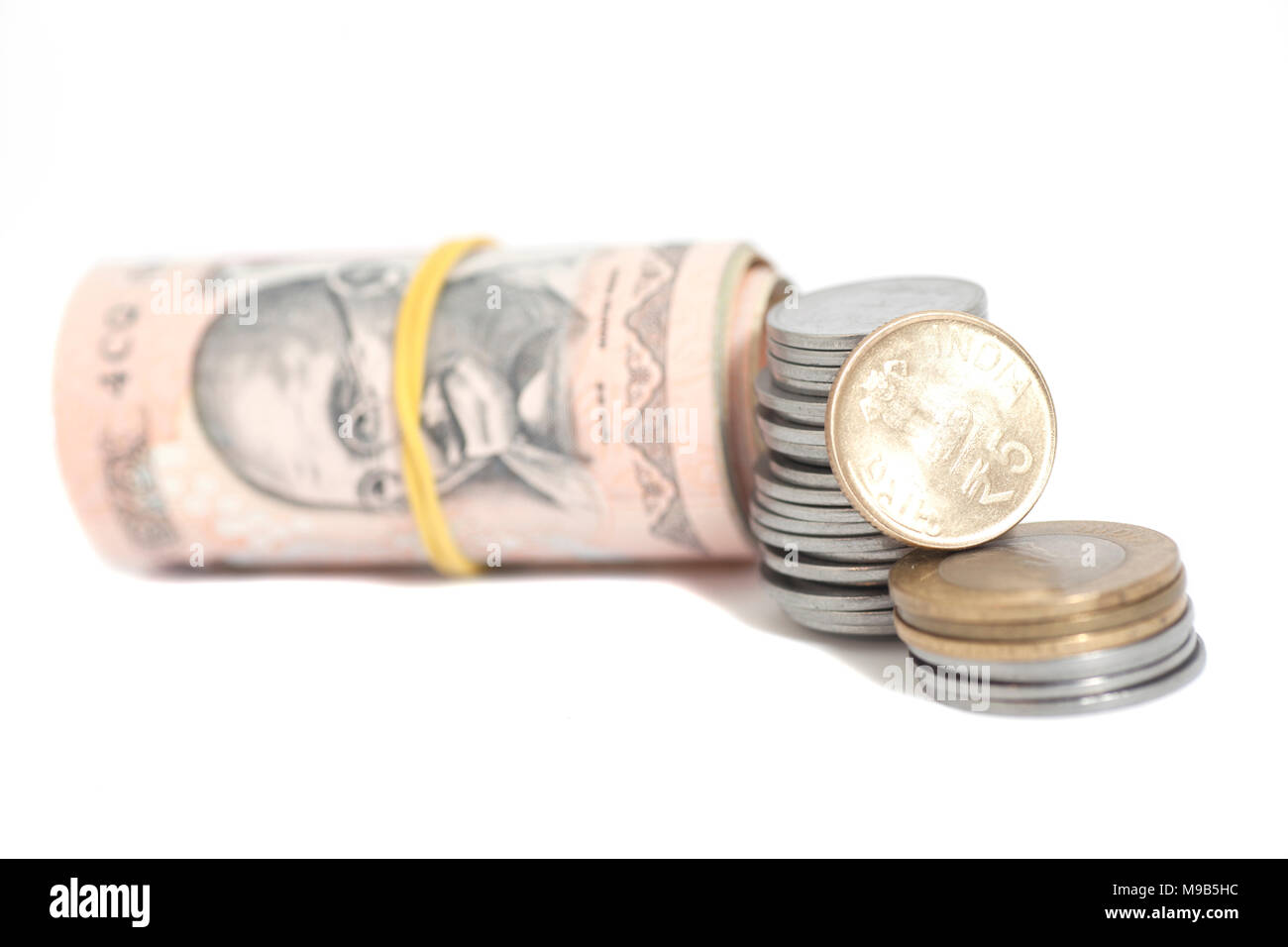 Roll of Indian Currency Rupees Notes and Coins on white Stock Photo - Alamy