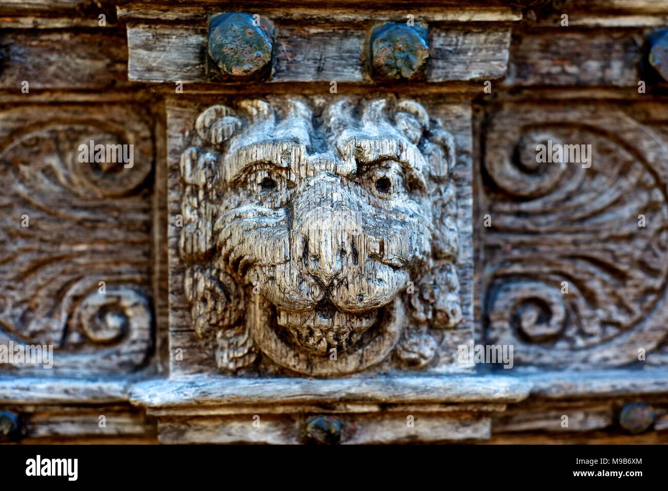 Wood Carving of faces on medieval doors Stock Photo - Alamy