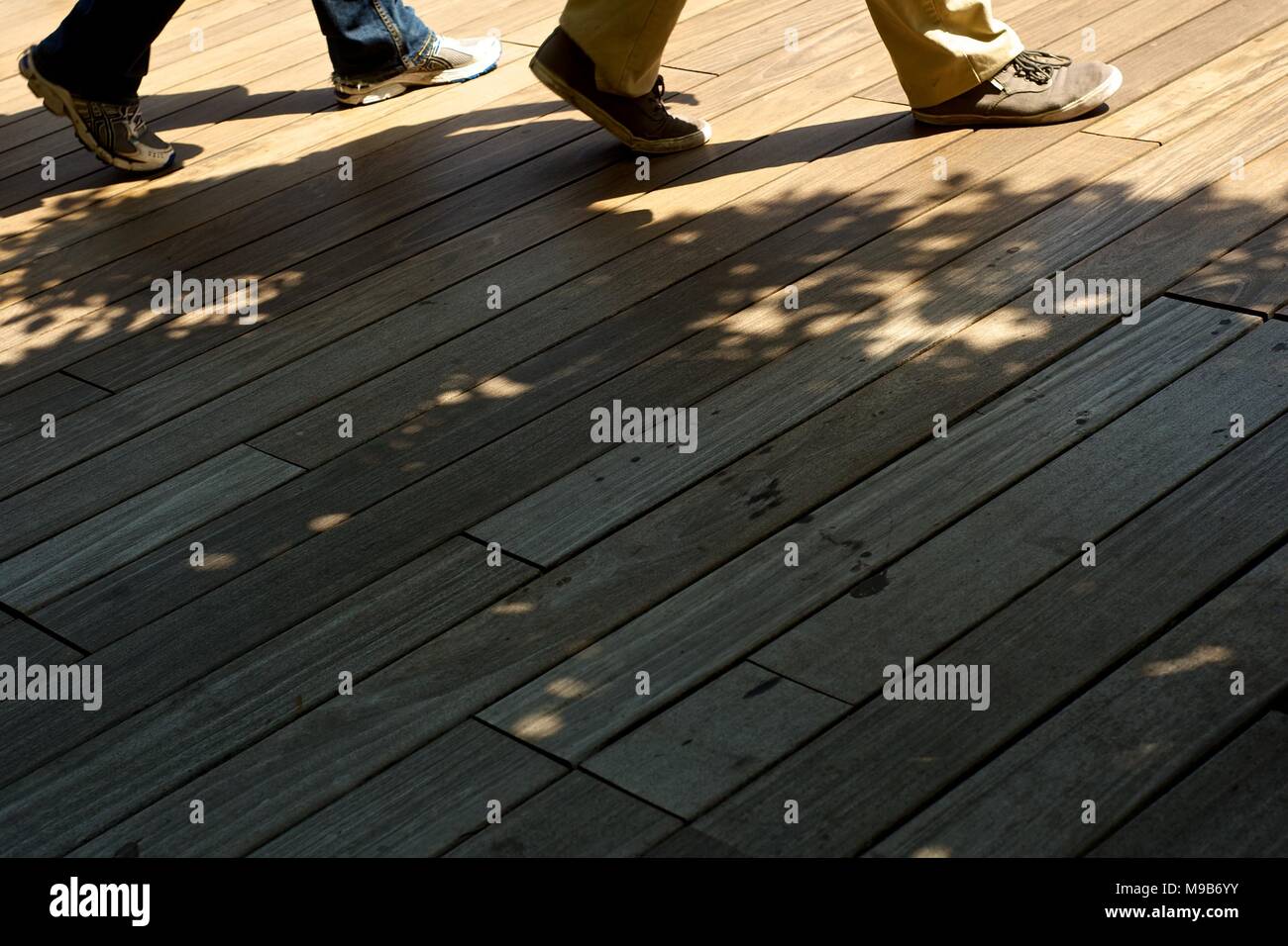 Shoes of people walking by on the High Line, Sun and shadow - New York ...