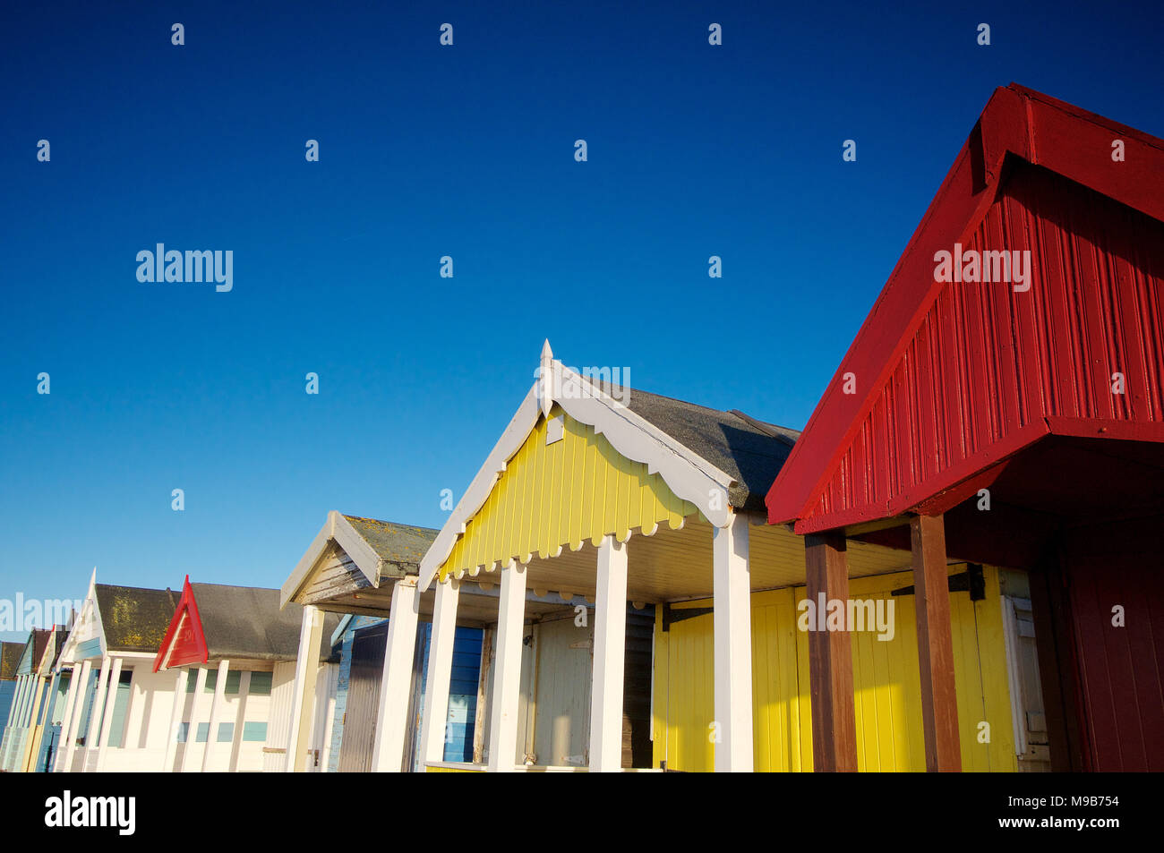 A row of colourful beach huts on the beach at Thorpe Bay, Southend-on ...