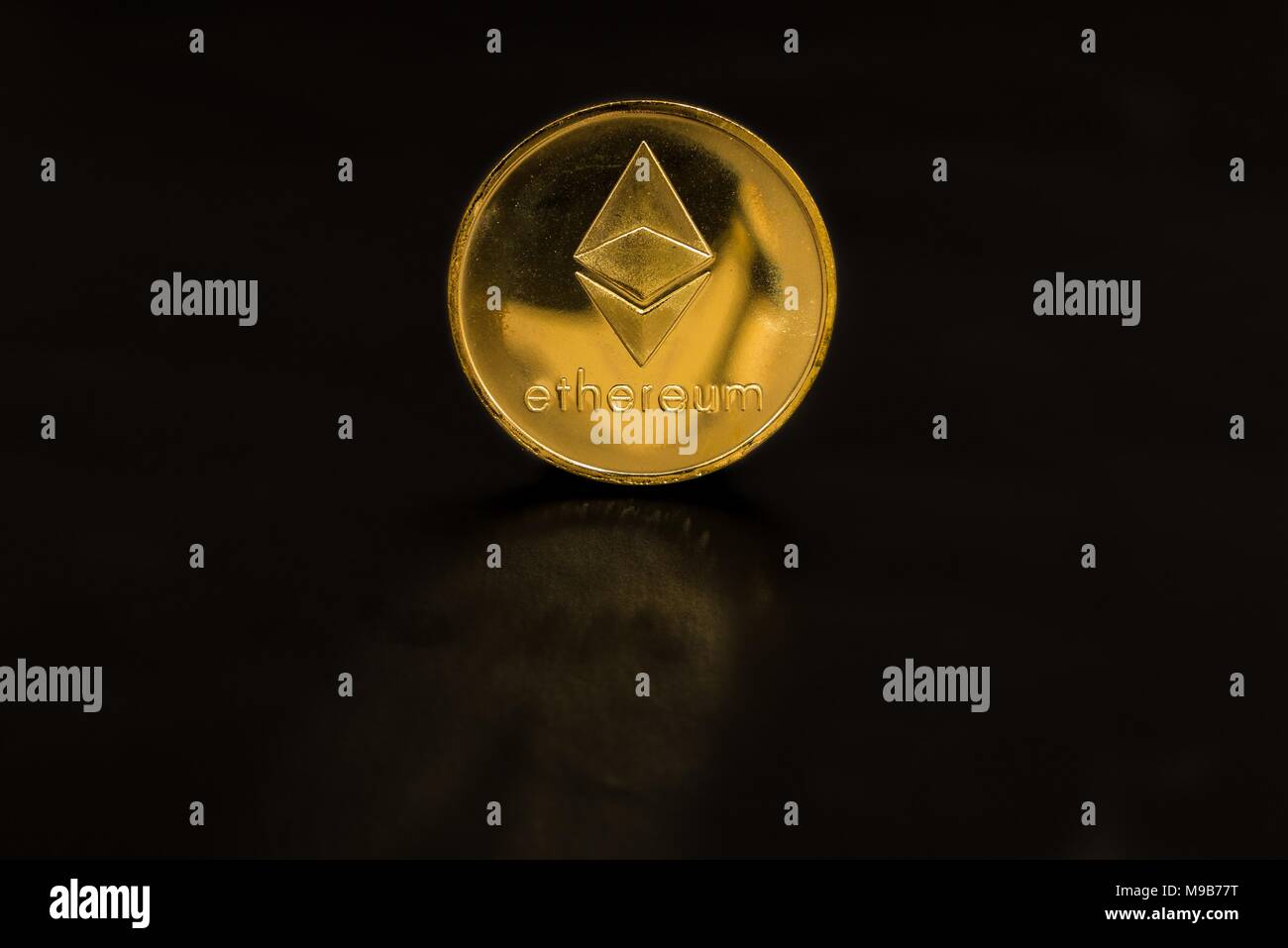 Gold coin Ethereum isolated on black background Stock Photo - Alamy