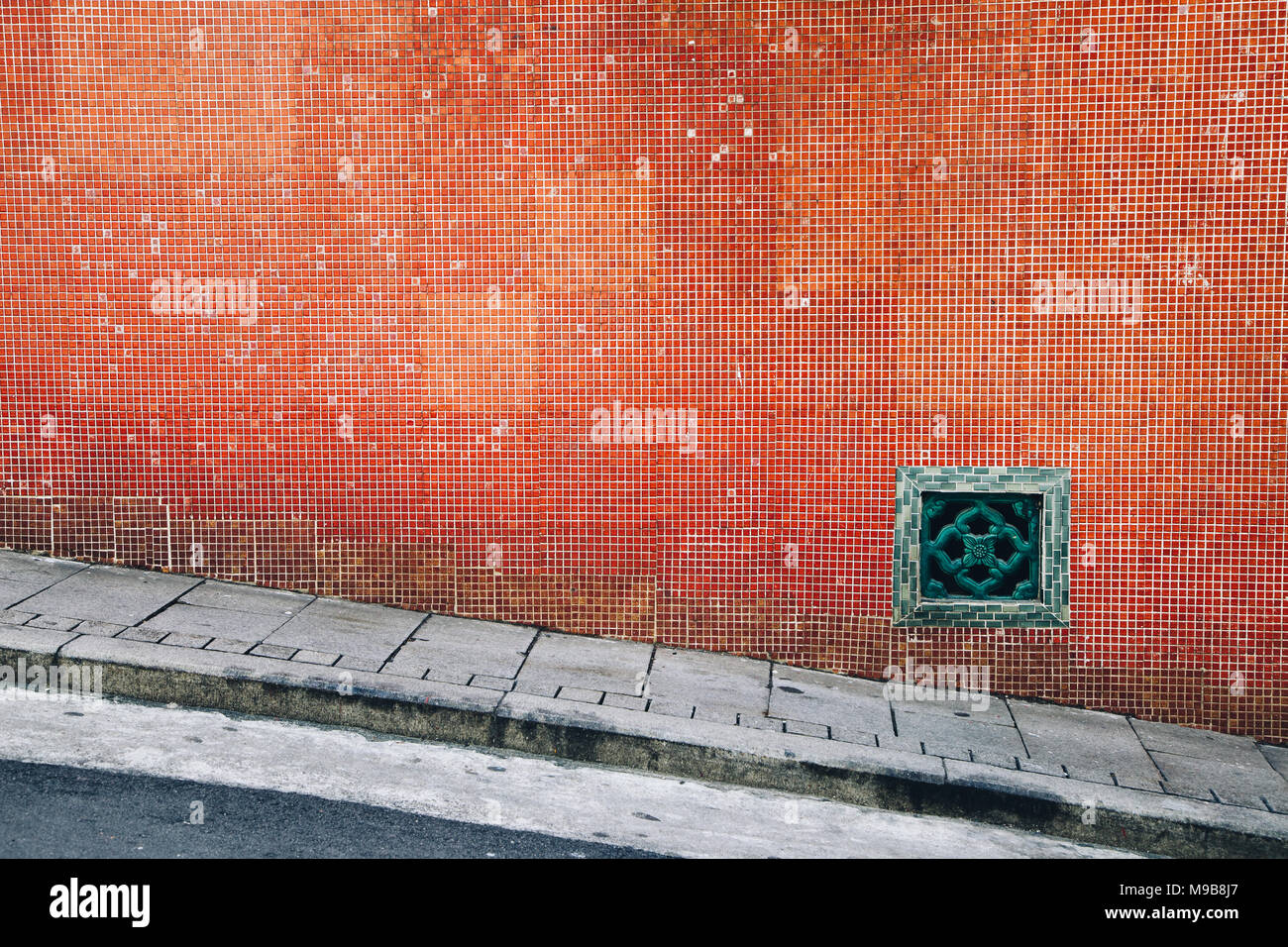 Old red tile wall and sloping street in Hong Kong Stock Photo - Alamy