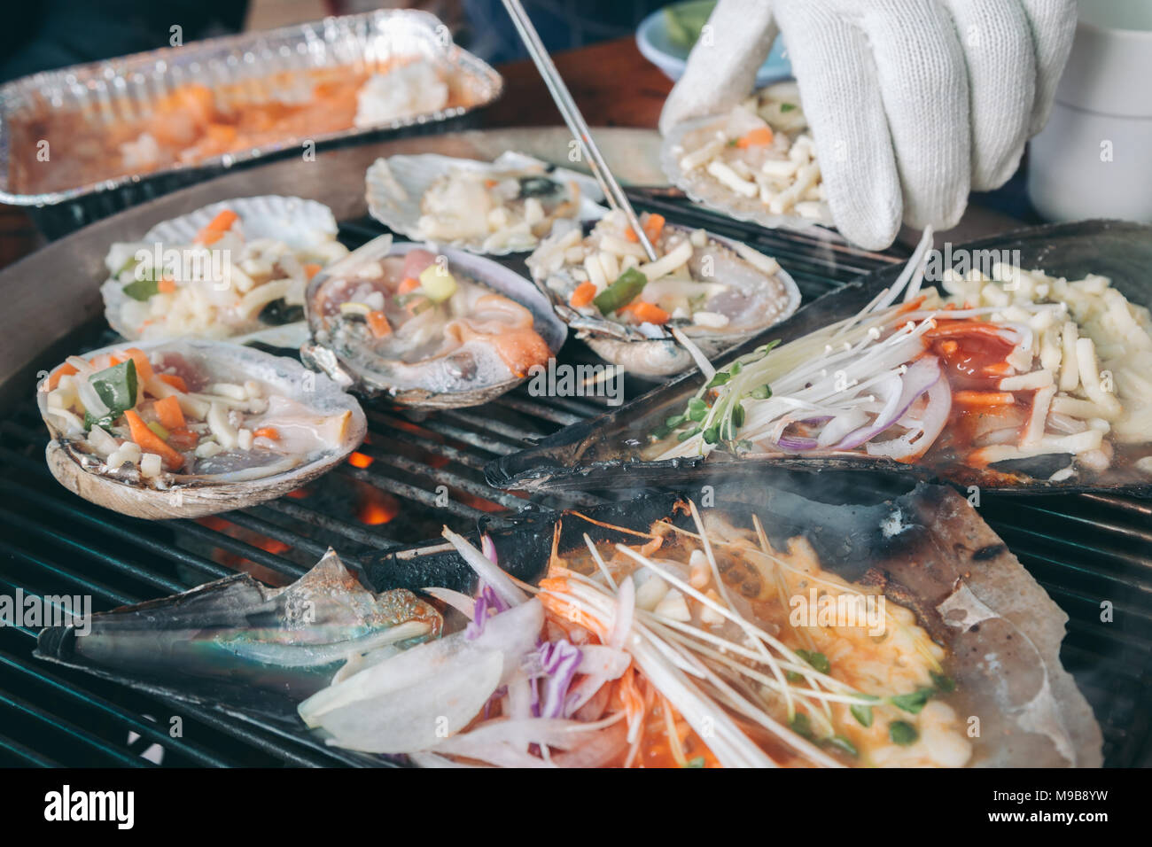 Grilled fresh seafood, Cooking BBQ seafood on fire Stock Photo - Alamy