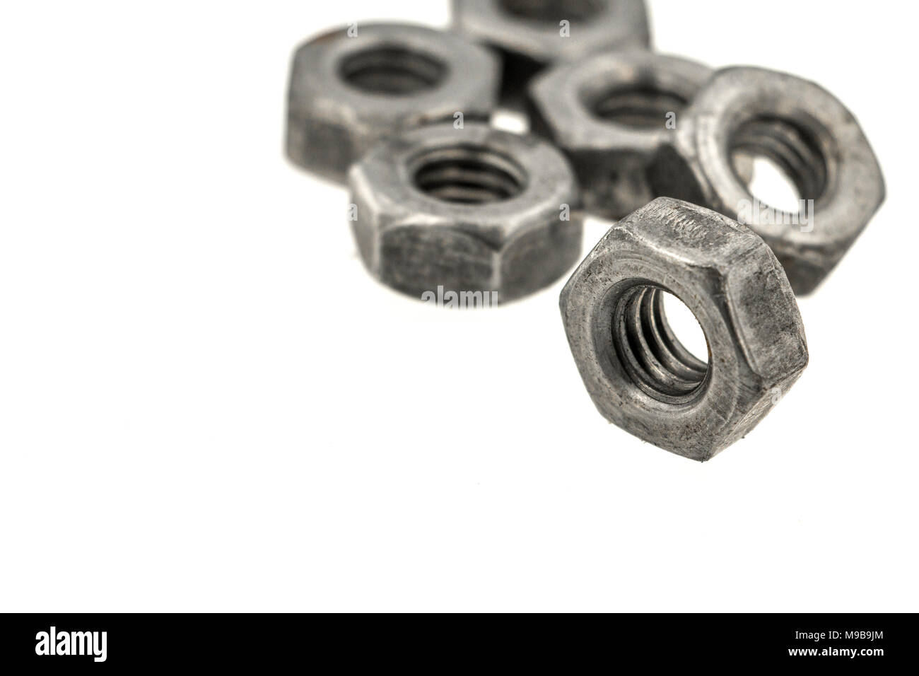 Steel nuts close up isolated on white background Stock Photo - Alamy