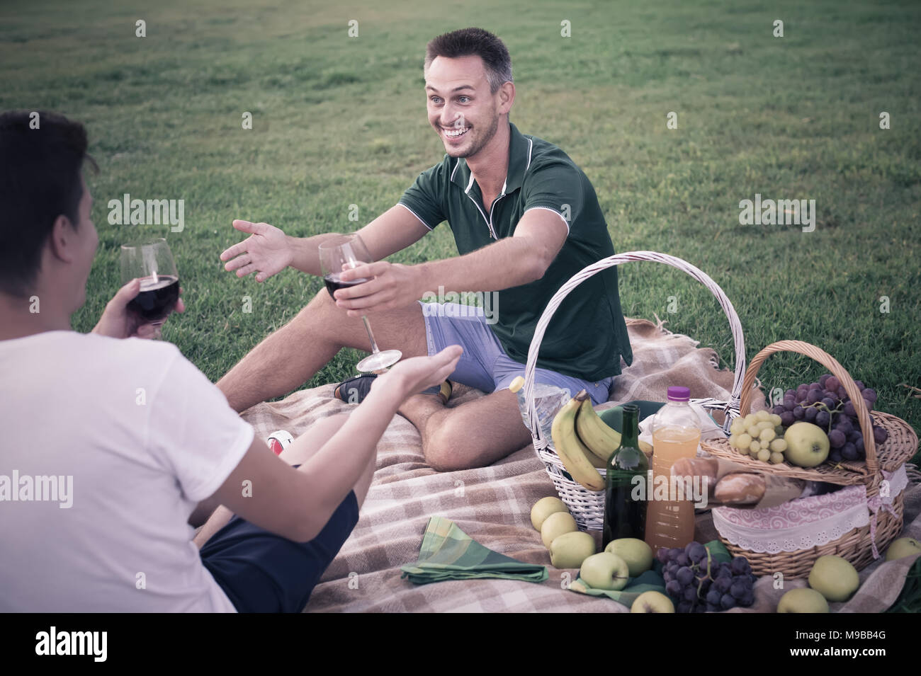 Two men enjoying life on picnic outdoors in male company Stock Photo ...