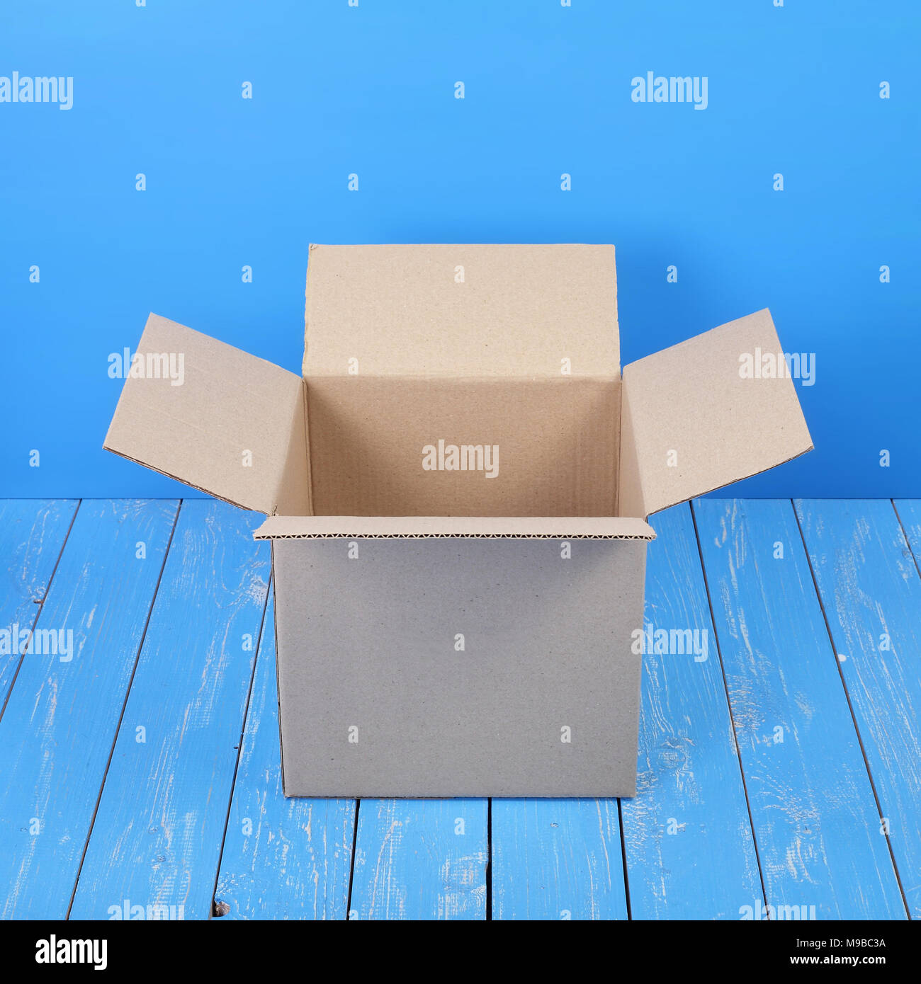 Postage and packing service - Open Package on a blue wood background ...