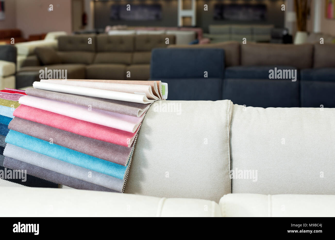 Samples of material for a new sofa in the store Stock Photo - Alamy