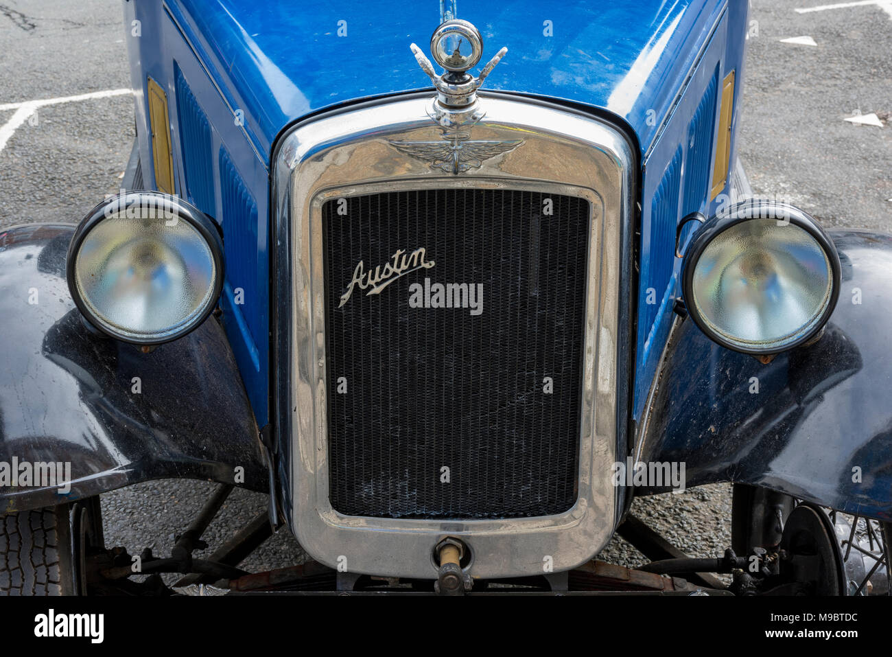 the radiator grill and badge with headlights on an old vintage austin ...