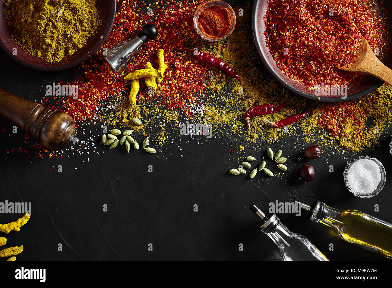 Cooking using fresh ground spices with big and small bowls of spice on ...