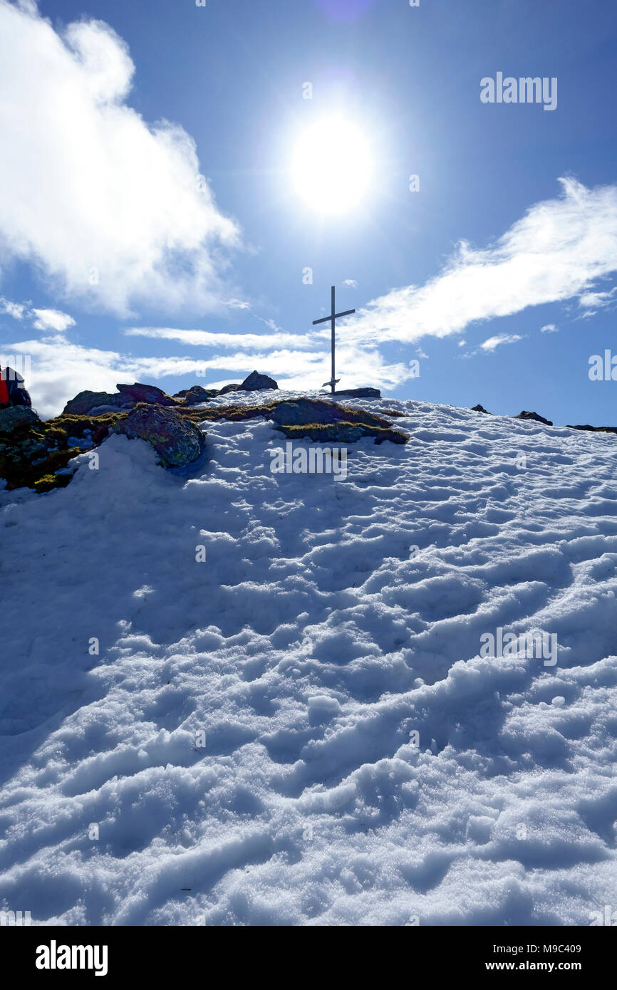 The sun shining above the cross just below the summit of Ben Ledi ...