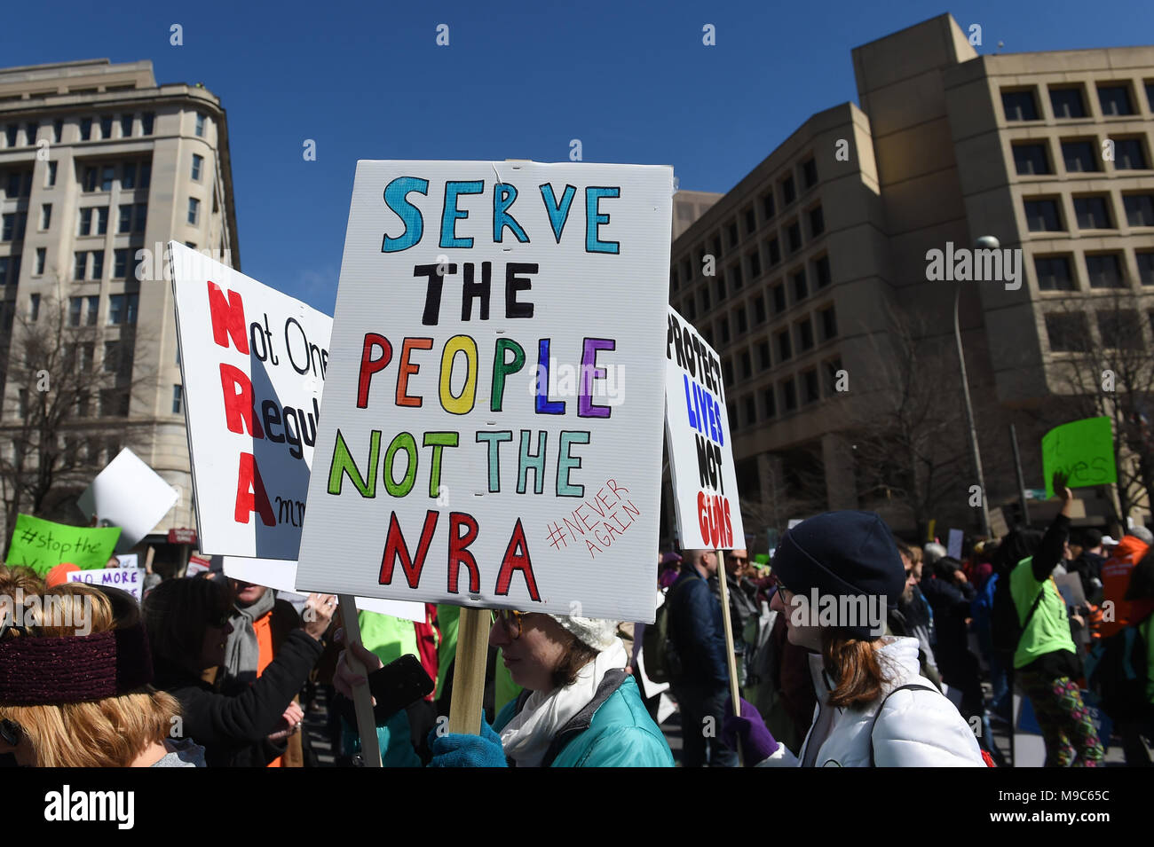Washington, DC, USA. 24th Mar, 2018. Protesters march with their signs ...
