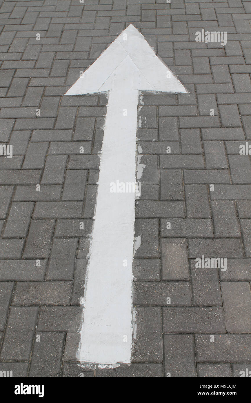Arrow sign on street, go forward on asphalt Stock Photo - Alamy