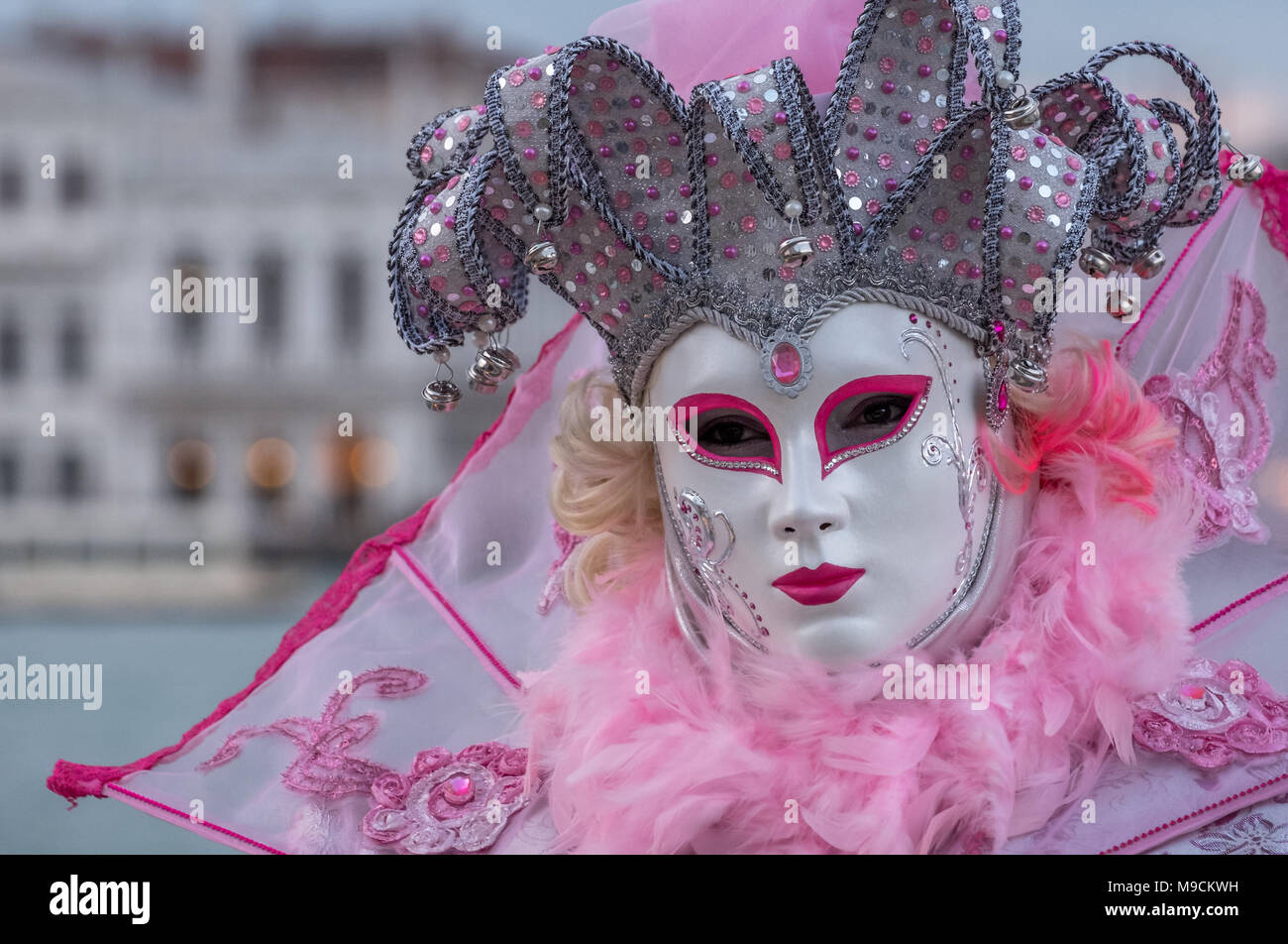 Venice Italy, February 2018. Woman in mask and ornate pink jester's ...