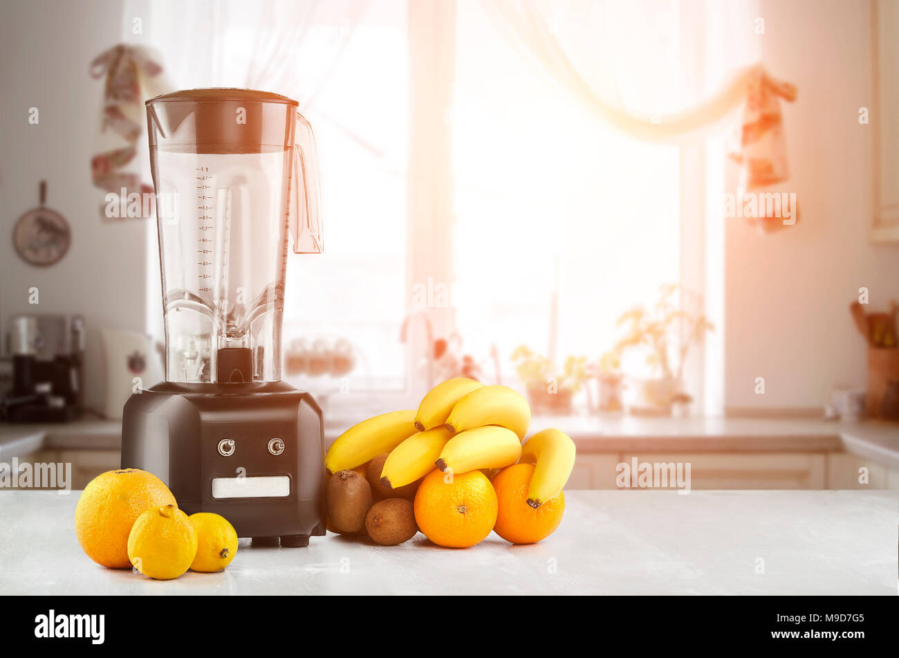 Metal food blender close-up with fresh exotic tropic fruits next to it ...