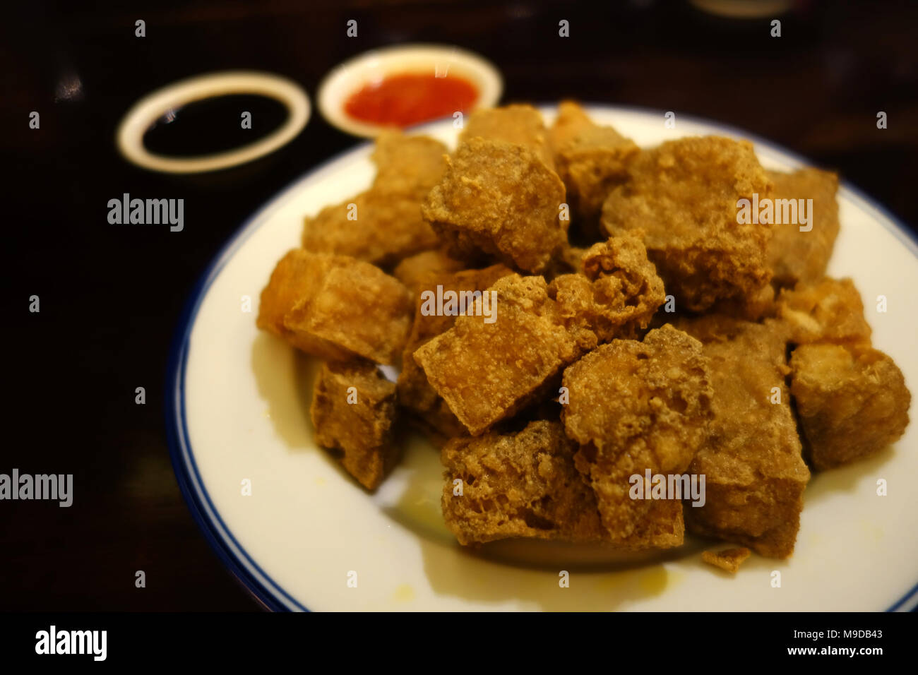 Fried stinky tofu with sauce on the side Stock Photo - Alamy