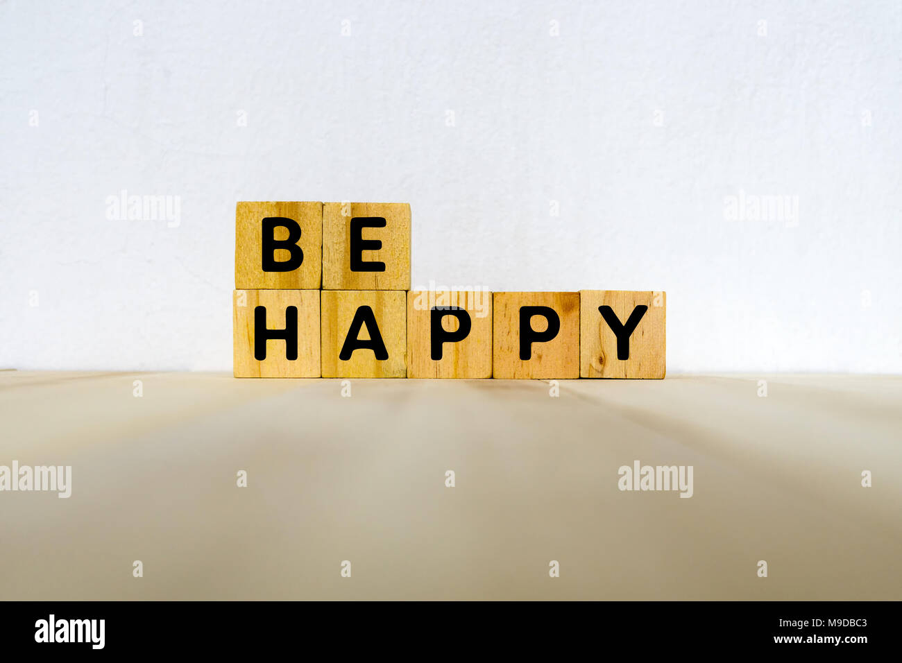 Be happy word on wood block - motivational concept Stock Photo - Alamy