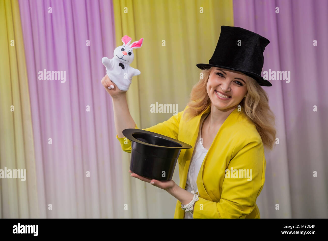 Woman magician shows tricks Stock Photo - Alamy