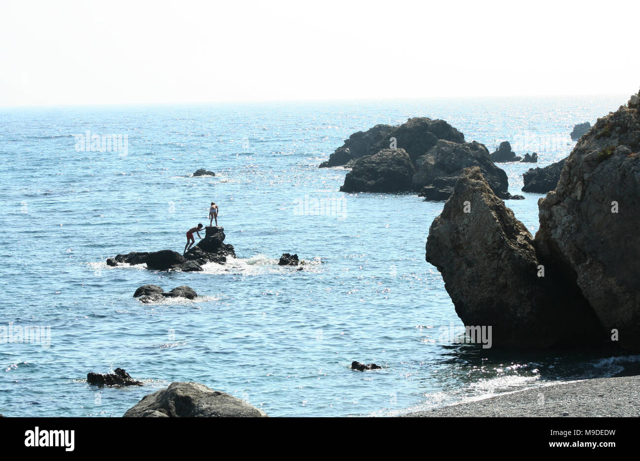 People jump of a rock in the sea Stock Photo - Alamy