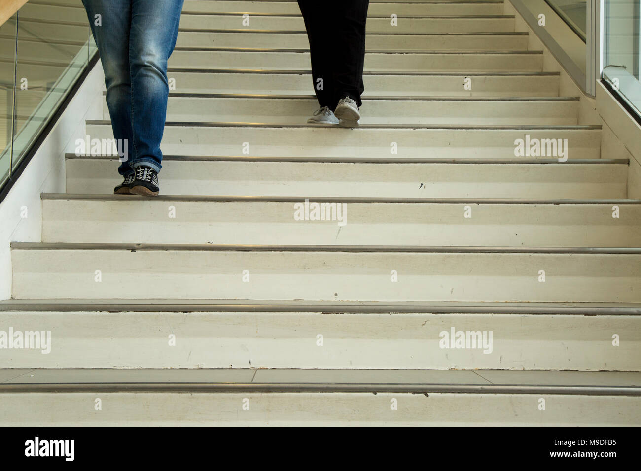 People walking down the stairs Stock Photo - Alamy
