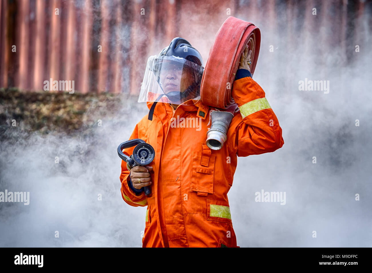 Emergency Fire Rescue training, firefighters in uniform, carry a water ...