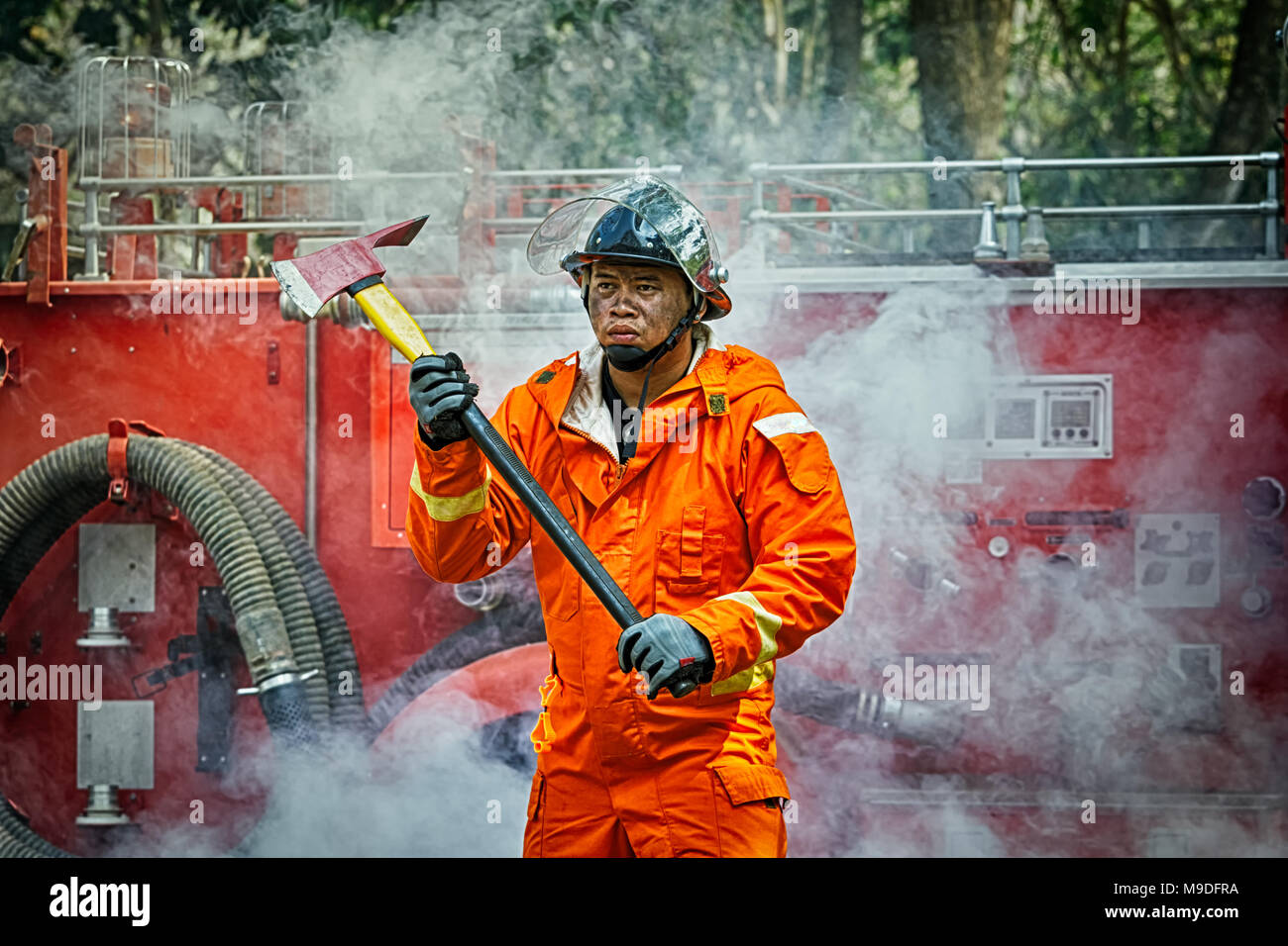 Emergency Fire Rescue training, firefighters in uniform, arm with a ...