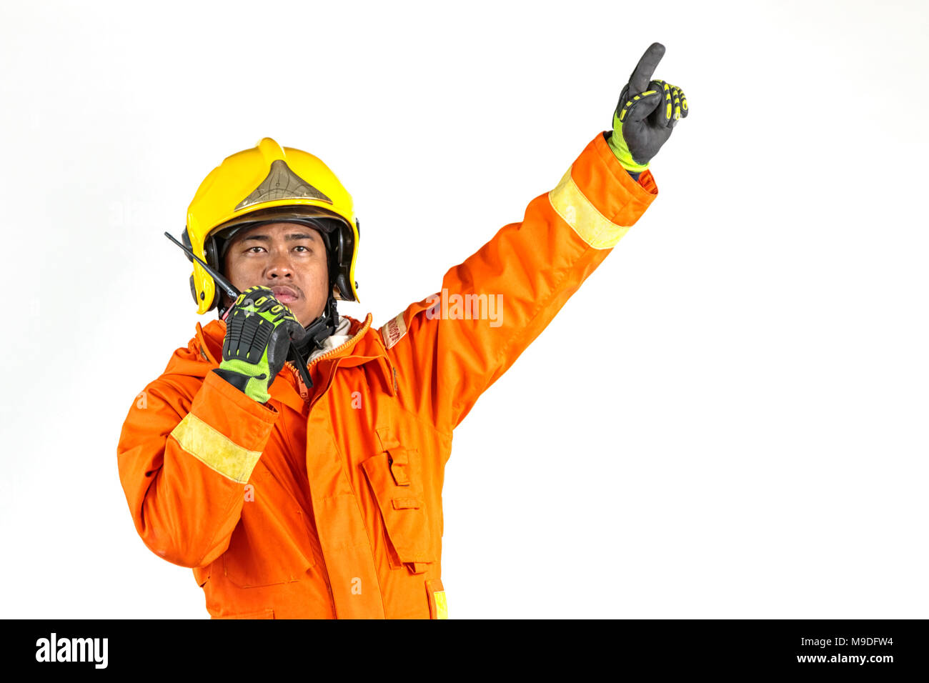 Firefighter in uniform and safety helmet standing full body length ...