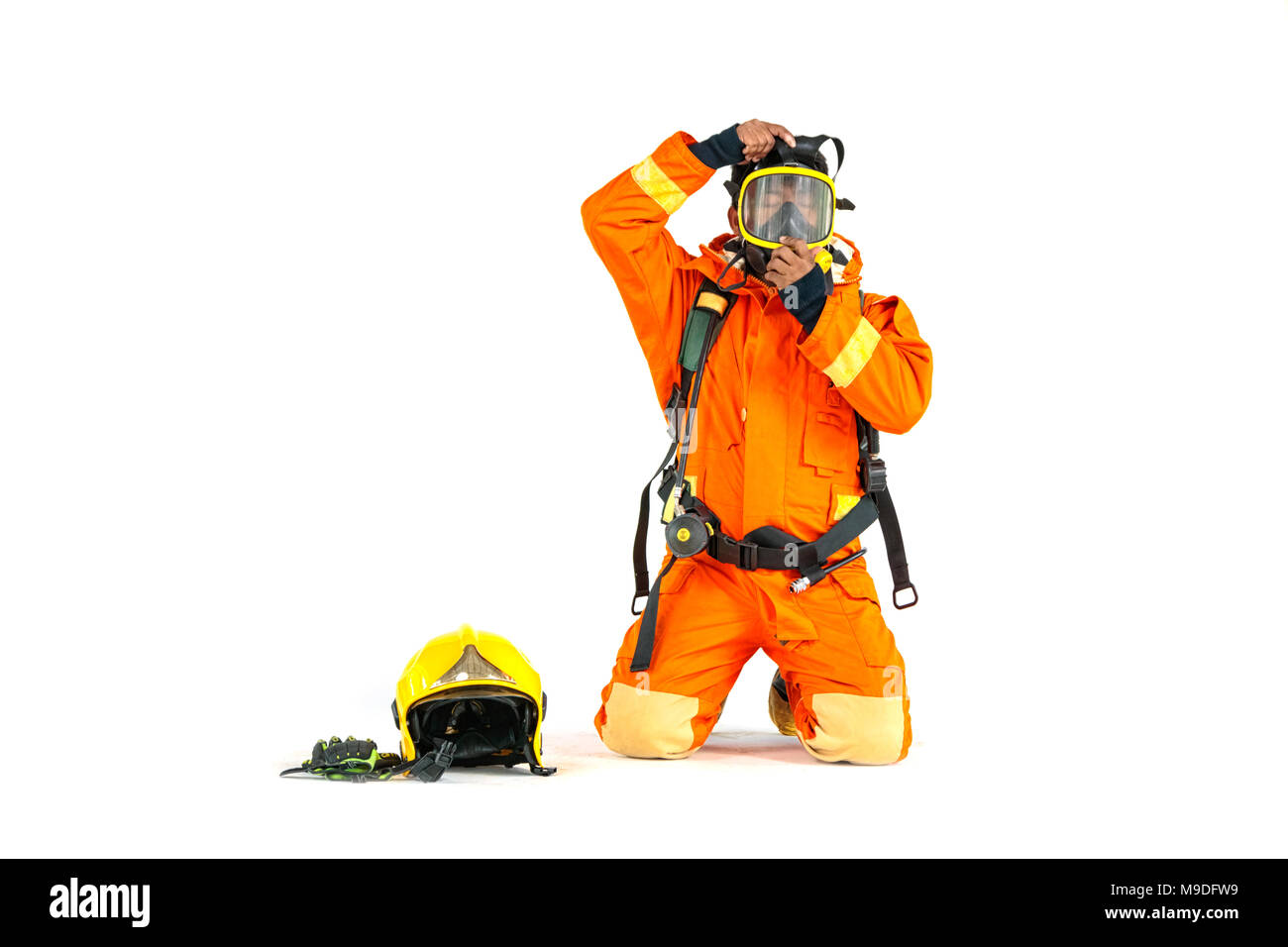 Firefighter in uniform and safety helmet standing full body length ...