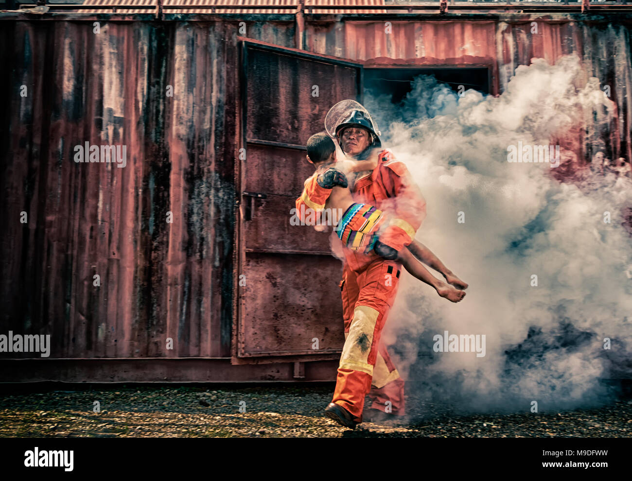 Firefighters save the boy from burnt place Stock Photo - Alamy