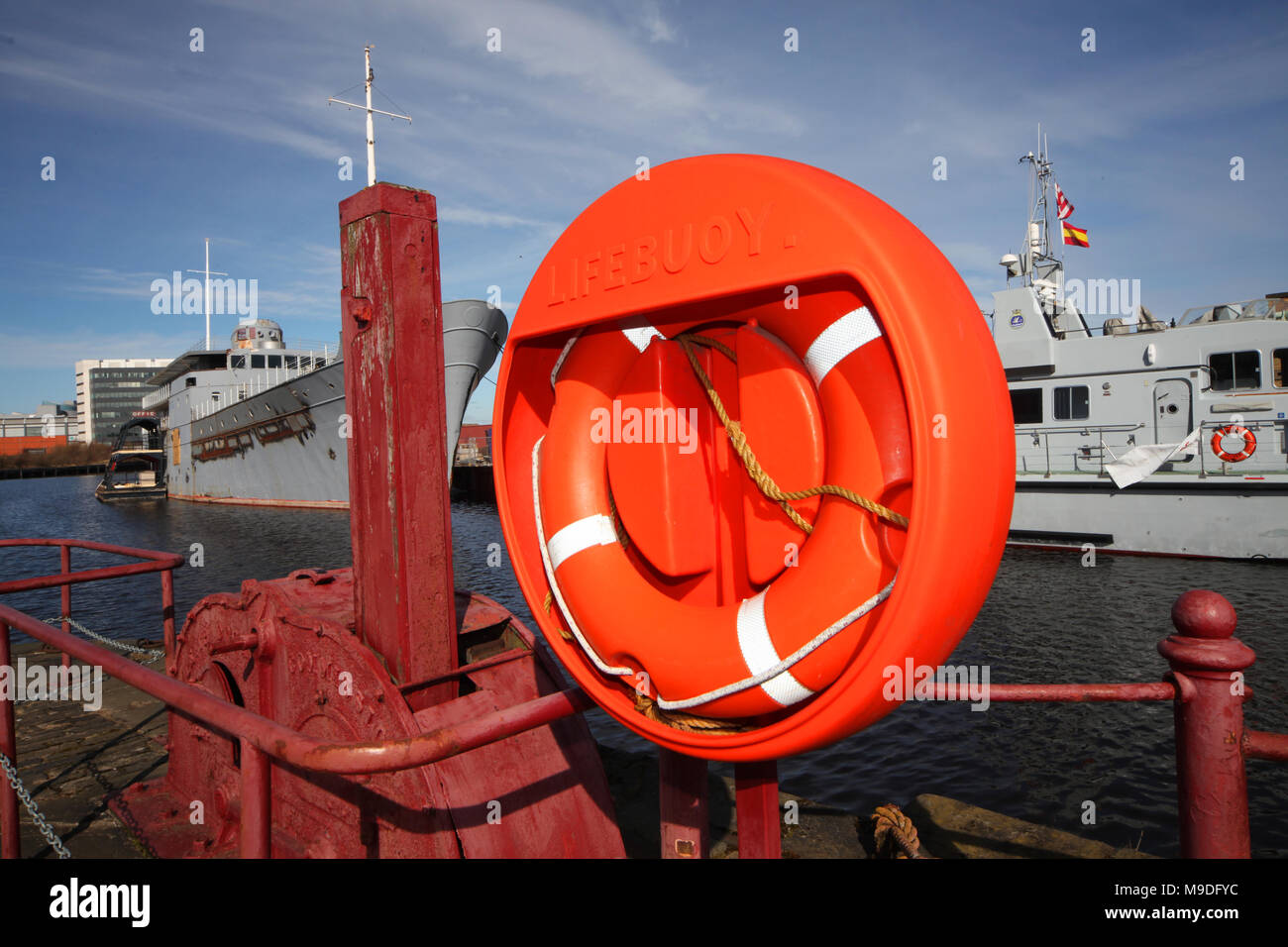 On a sunny day the brightness of an orange lifebuoy is highlighted in ...