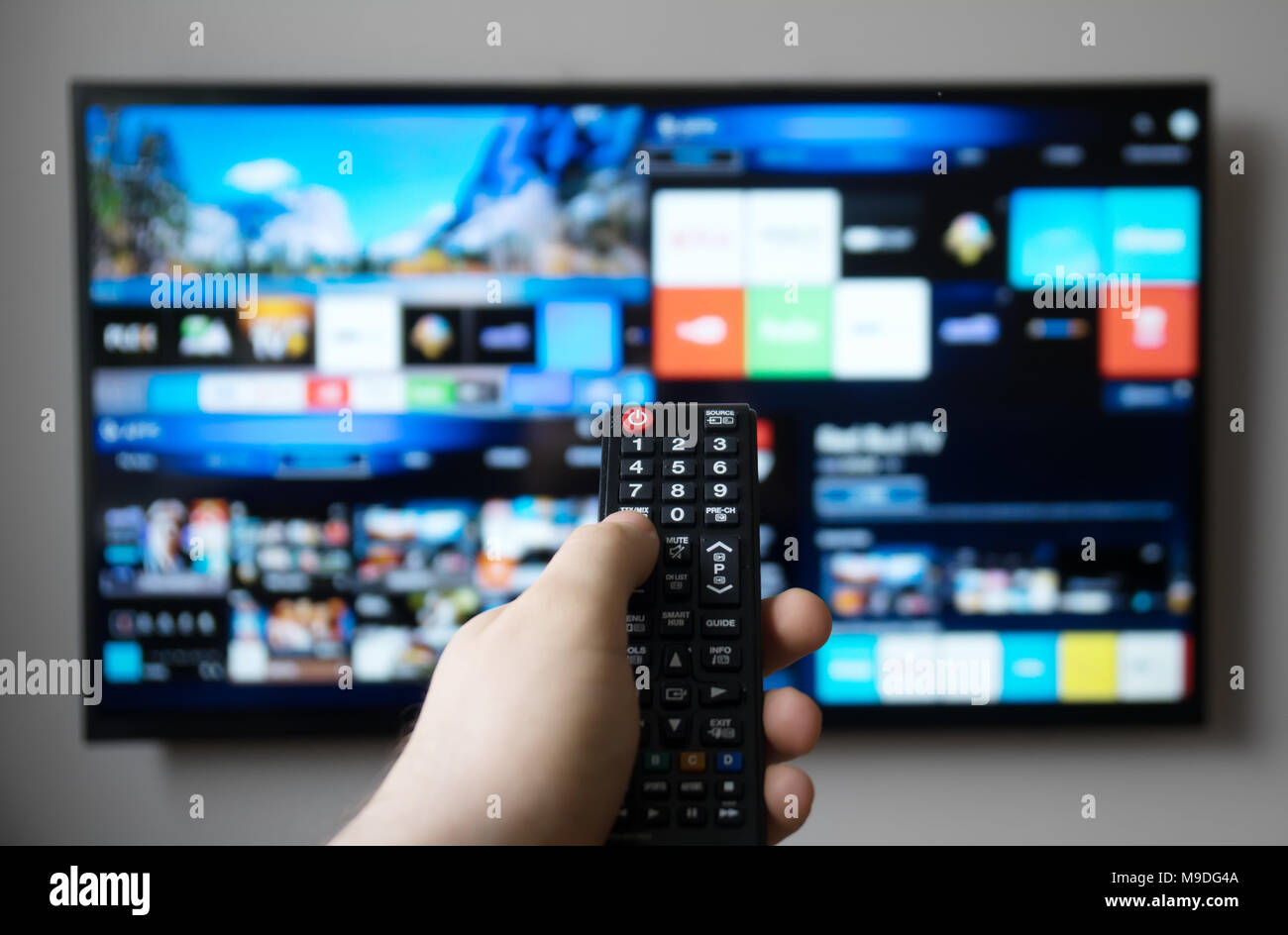 Male hand holding TV remote control. Smart TV Stock Photo - Alamy