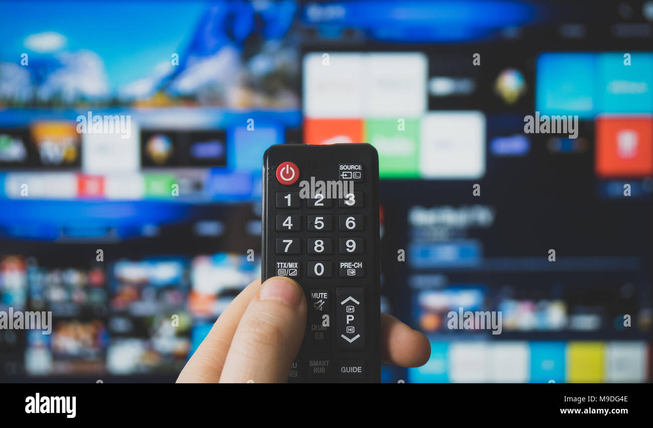 Male hand holding TV remote control. Smart TV Stock Photo - Alamy