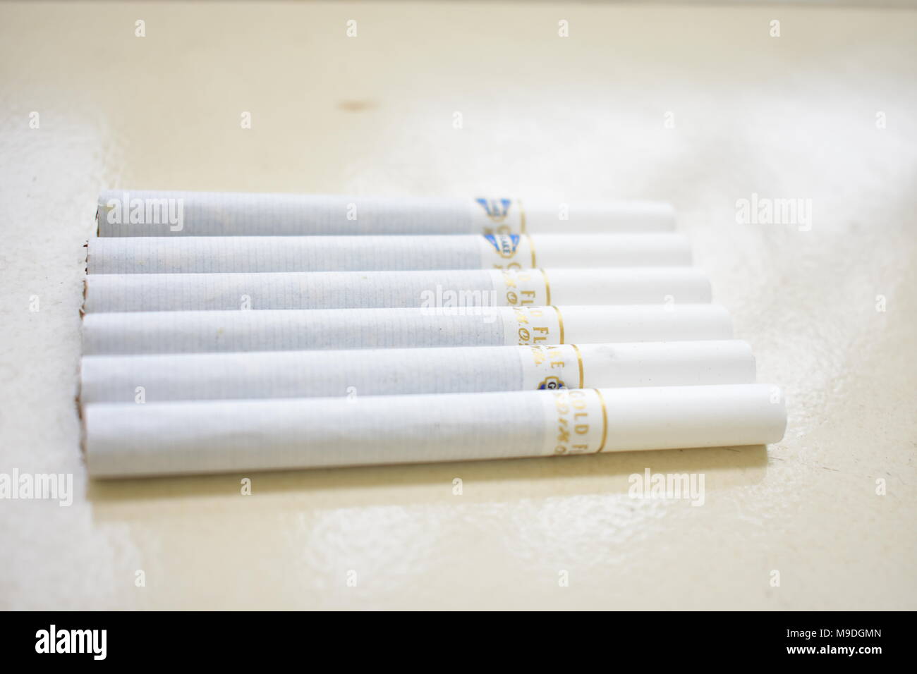 A close look bunch of cigarette at floor Stock Photo - Alamy
