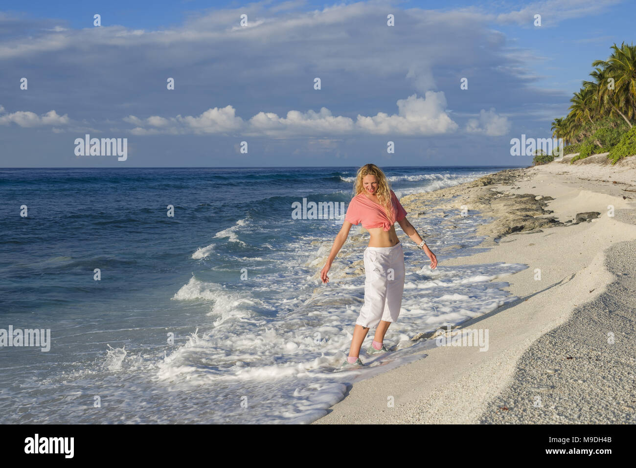 Woman on coral island beach hi-res stock photography and images - Alamy