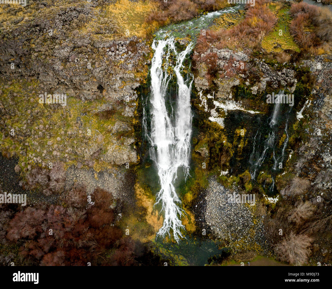 Aerial of waterfall as it is fed by creek and goes over a cliff Stock ...