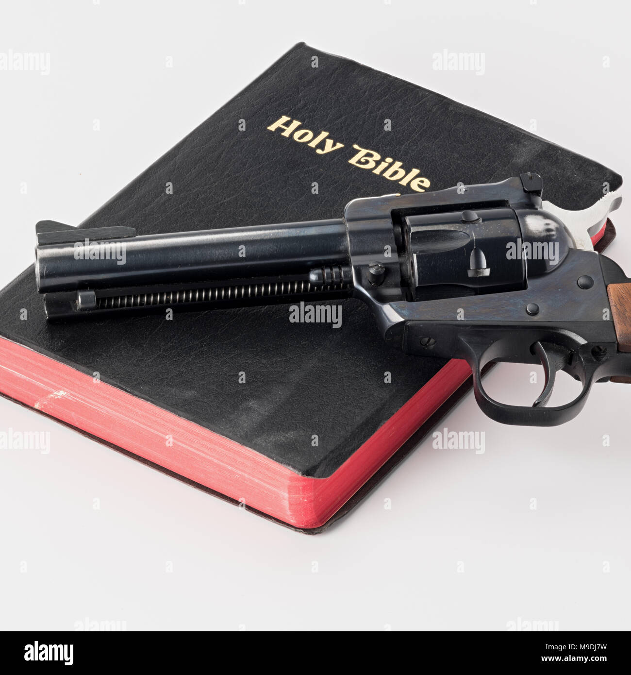 Religious Bible with a pistol handgun on it Stock Photo - Alamy