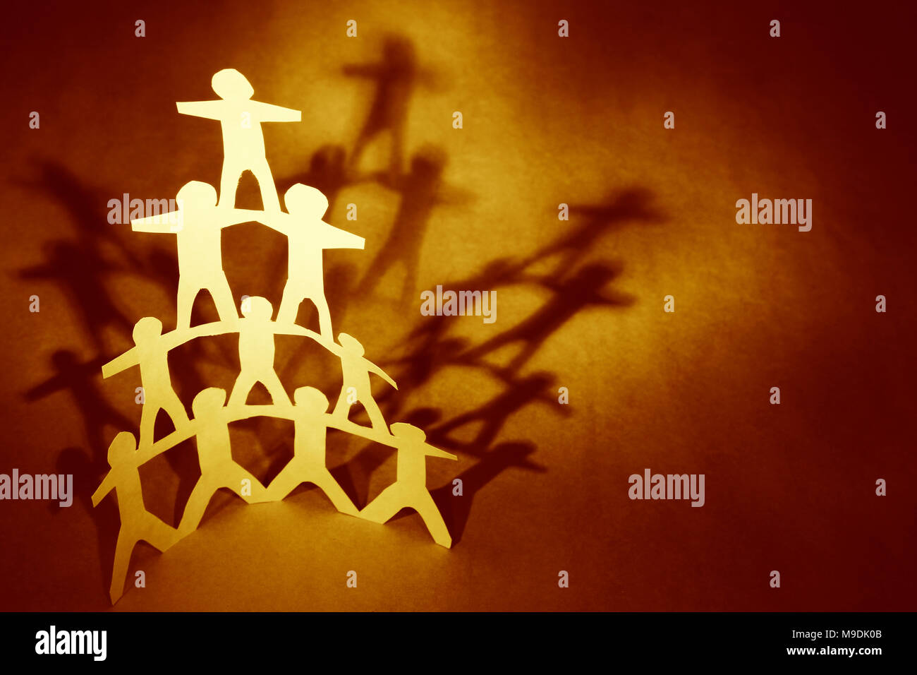 Human team pyramid supporting each other Stock Photo - Alamy