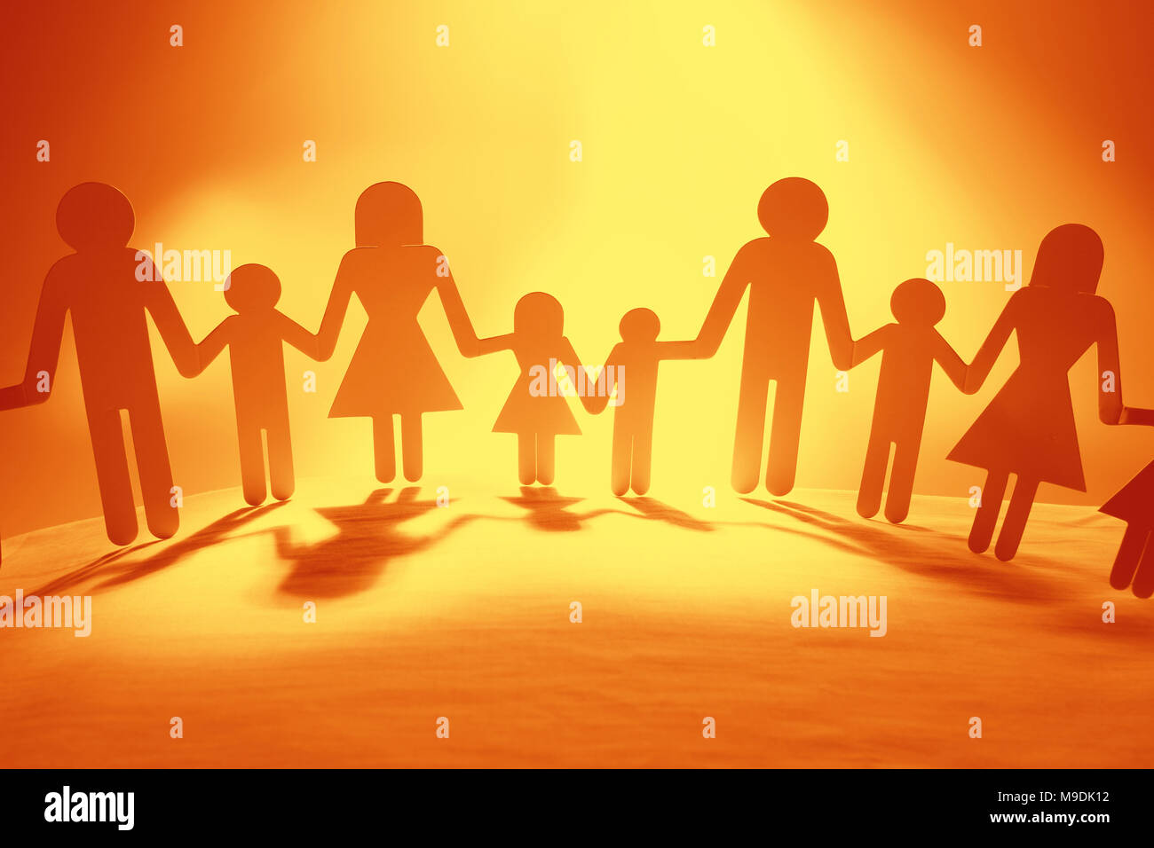 Family paper chain cutout holding hands Stock Photo - Alamy