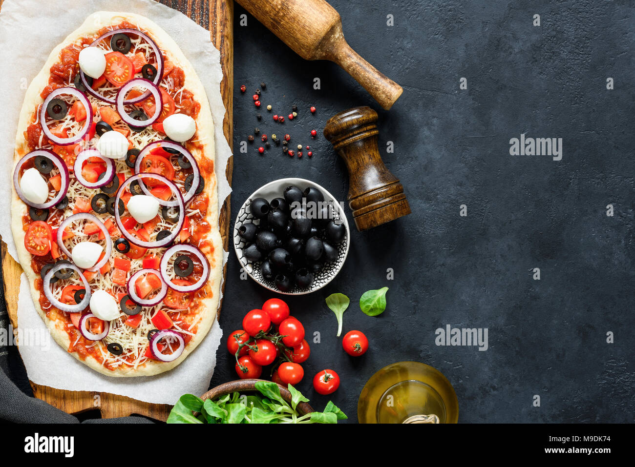 Pizza cooking. Homemade pizza. Preparation of pizza. Top view with copy ...