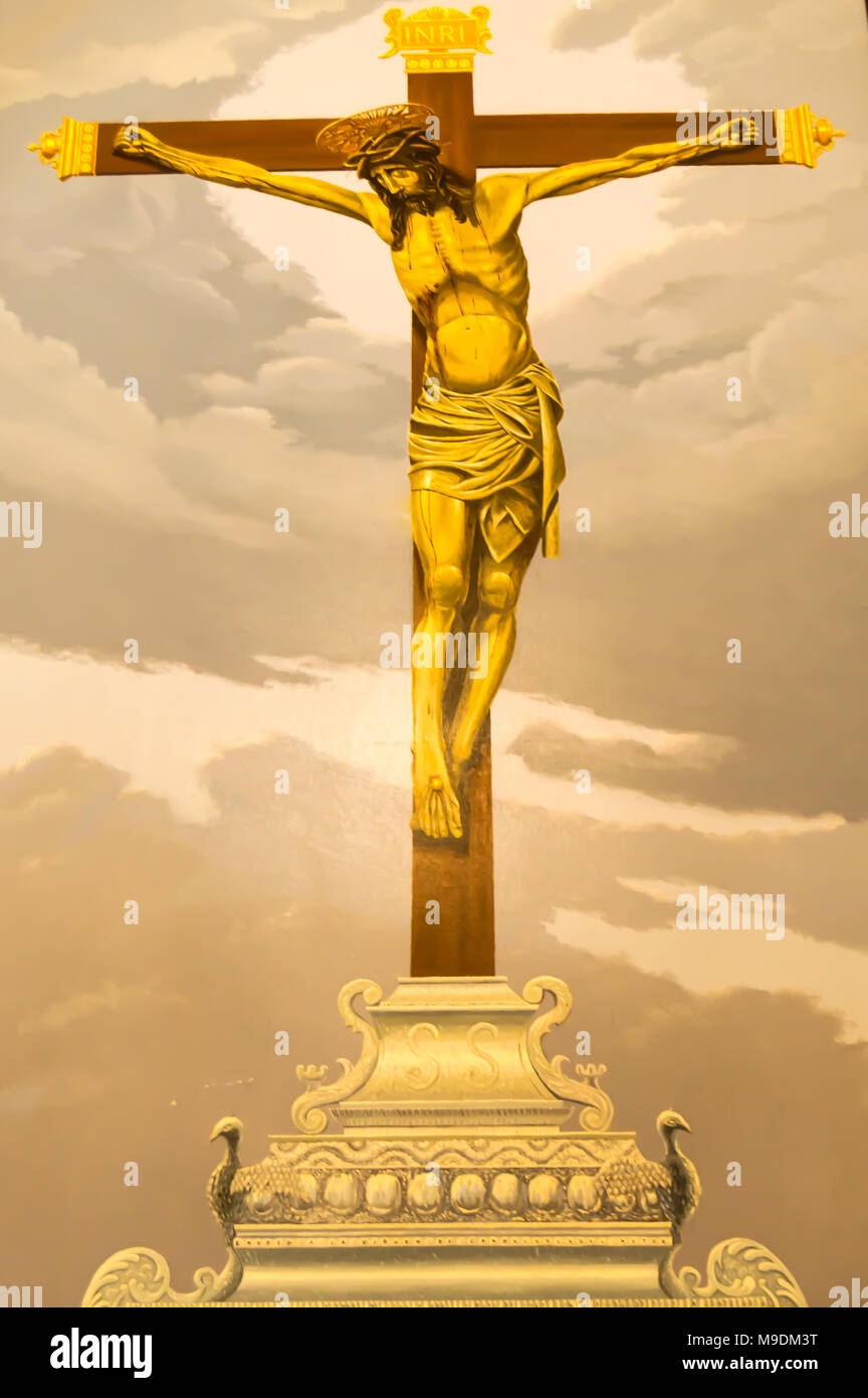 Painting of Jesus Christ on the cross with a background of gray clouds ...