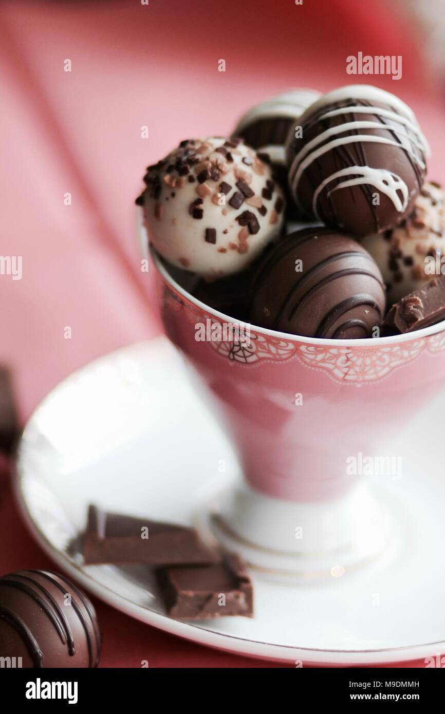 Chocolate truffles in a pink cup Stock Photo - Alamy