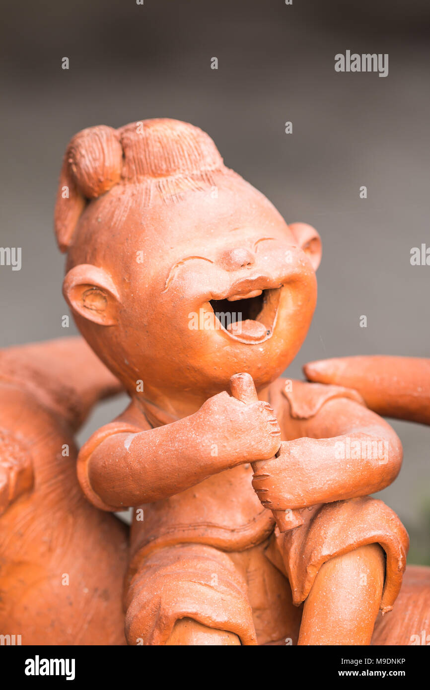 smiling kid made of clay in garden Stock Photo - Alamy