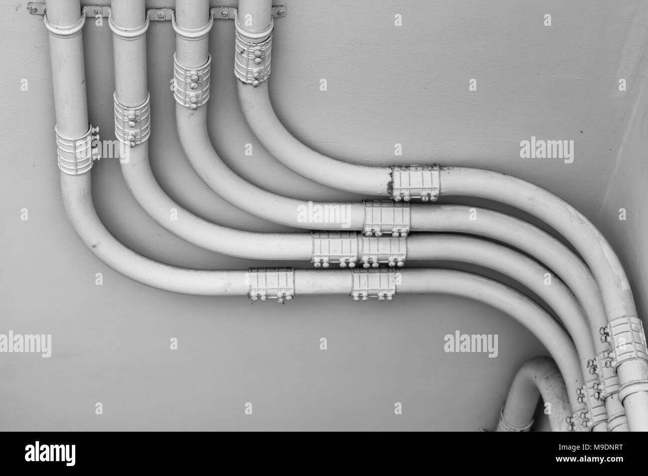 Pipe of electricity line on cement wall in black and white tone Stock ...