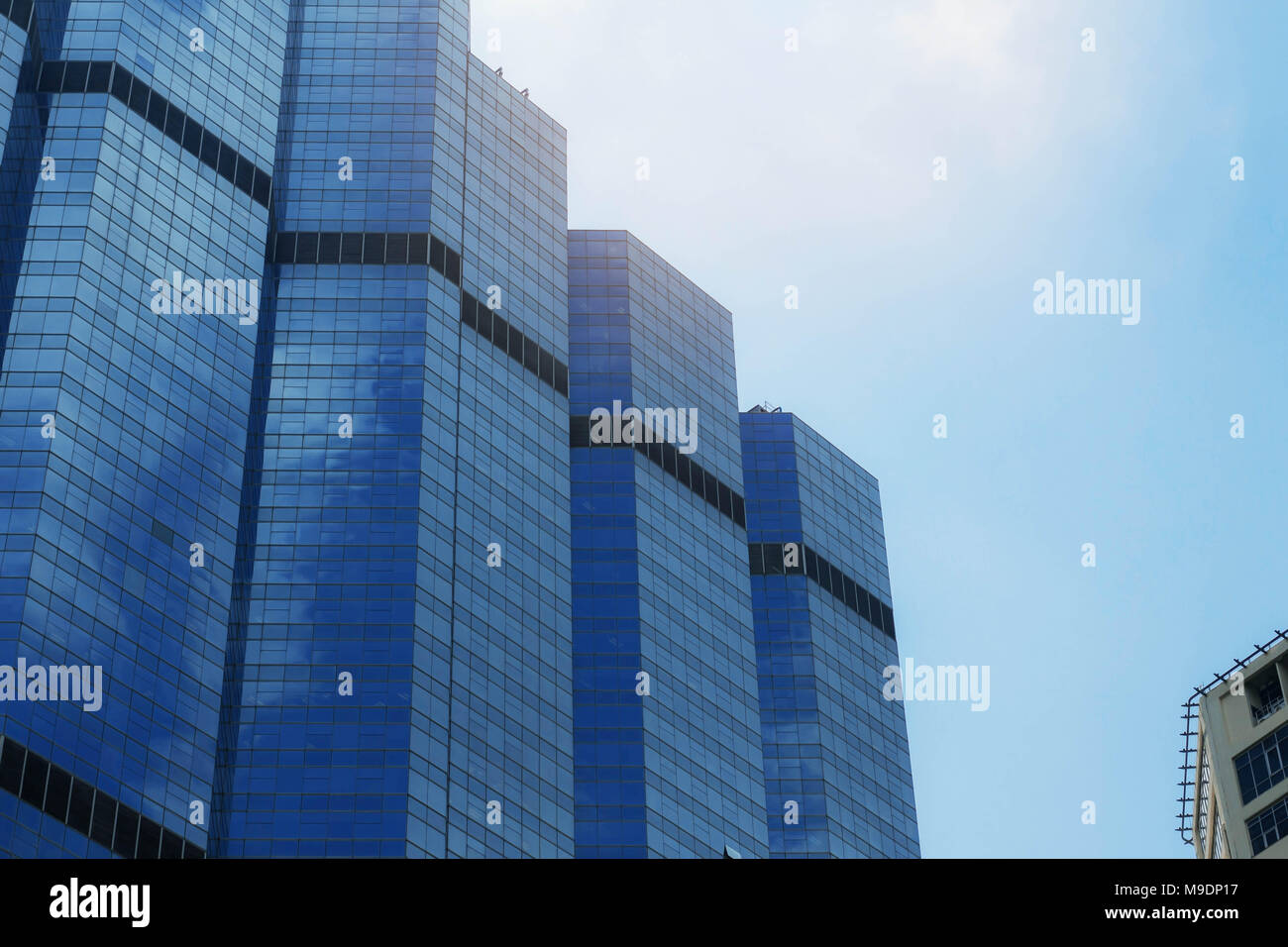 Blue office building in downtown with sky Stock Photo - Alamy
