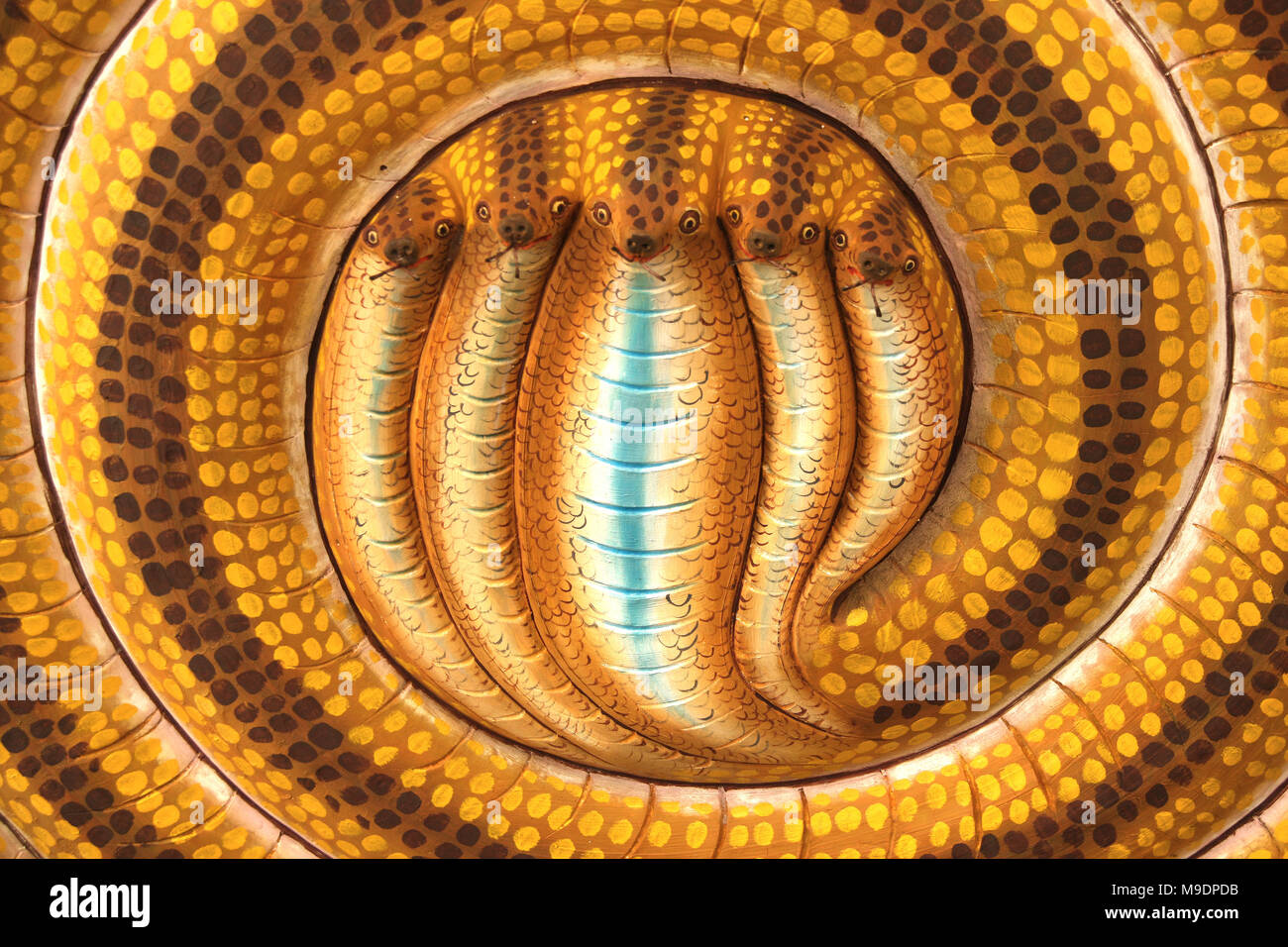 Wall ornament with a naga - snake with several heads in a Hindu temple ...