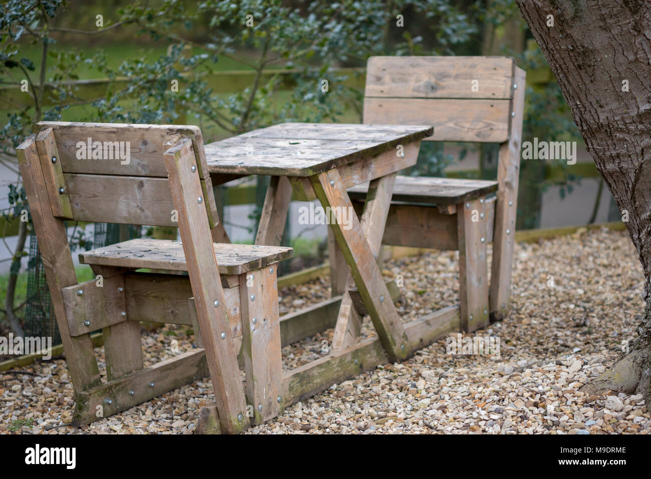 wooden picnic table and chair combination Stock Photo - Alamy